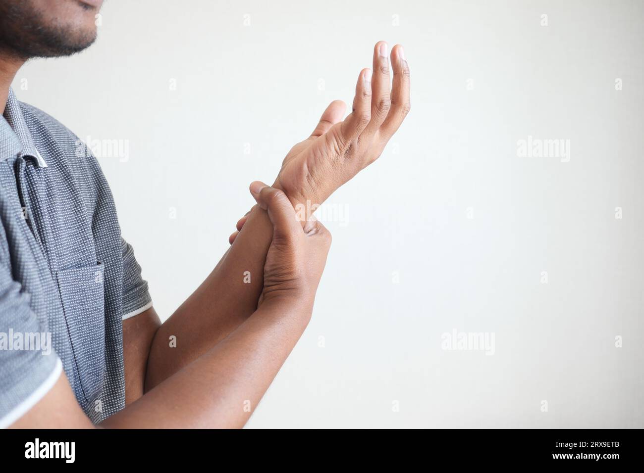 man suffering pain in hand close up Stock Photo - Alamy