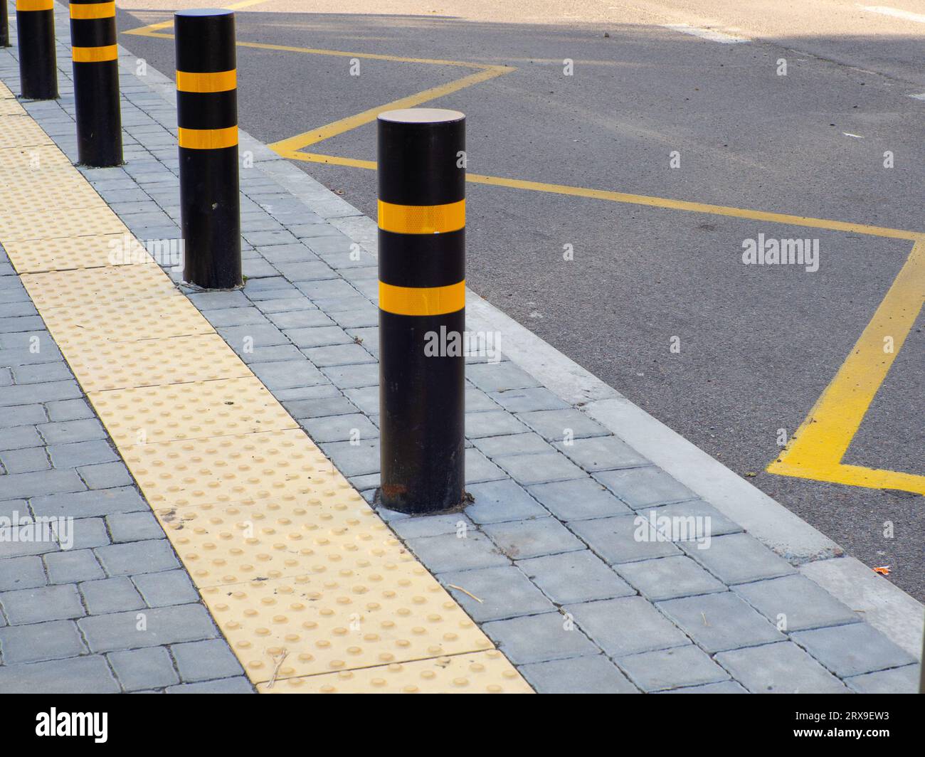 Yellow tactile pavement for the blind on the bus stop. Bus stop with ...