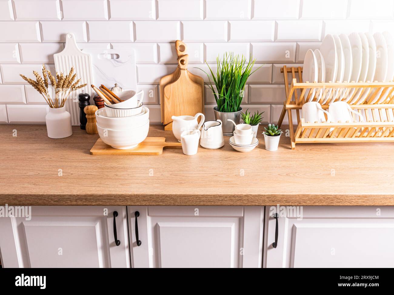 A set of stylish kitchen utensils plates, bowls, cutting boards, spoons ...