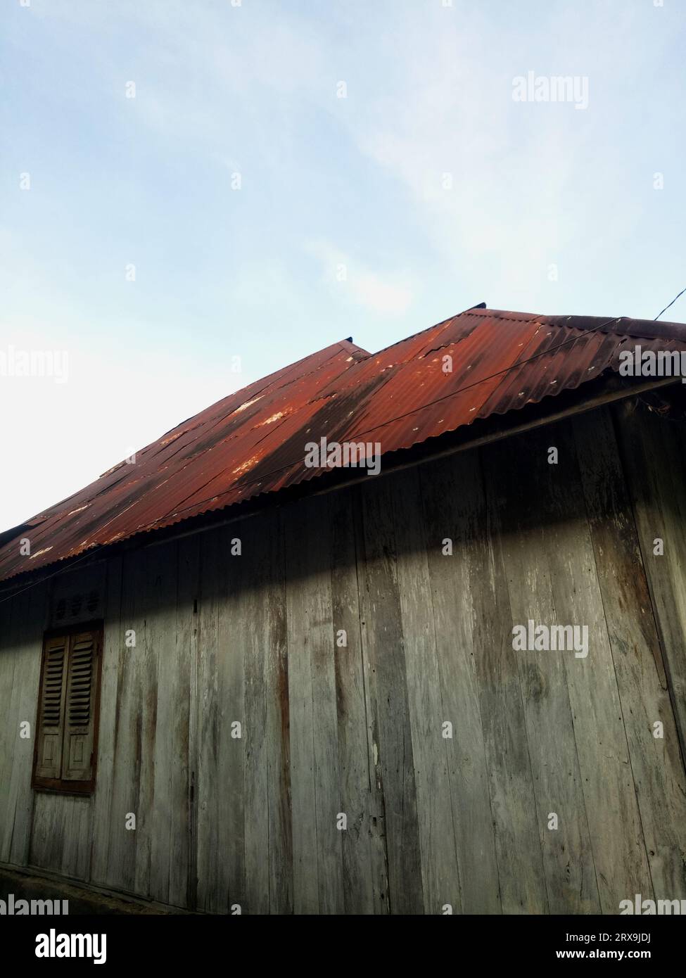 Old wooden house with rusty roof Stock Photo - Alamy