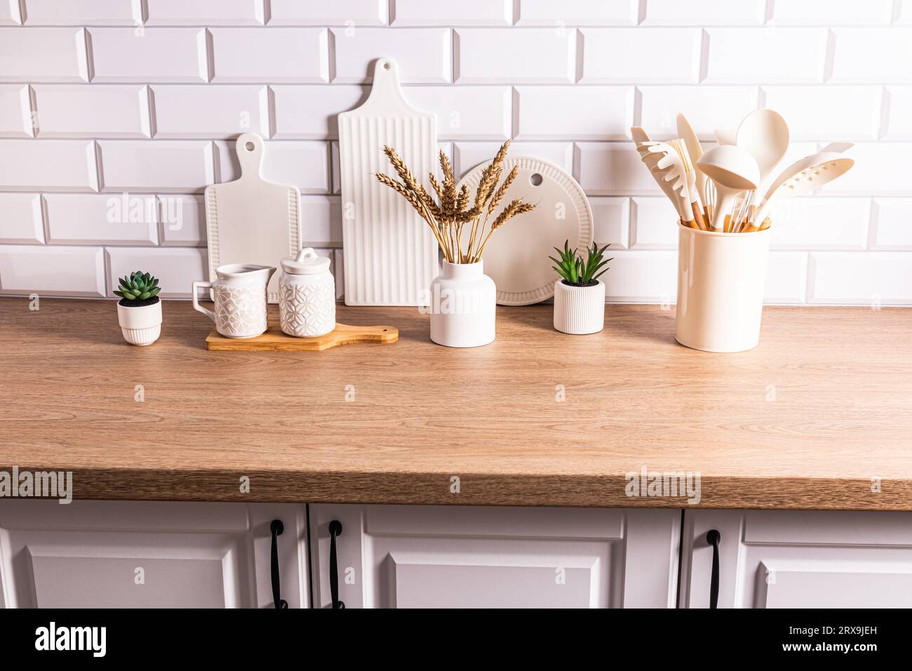 Many different items of kitchen wooden utensils on a wooden countertop ...
