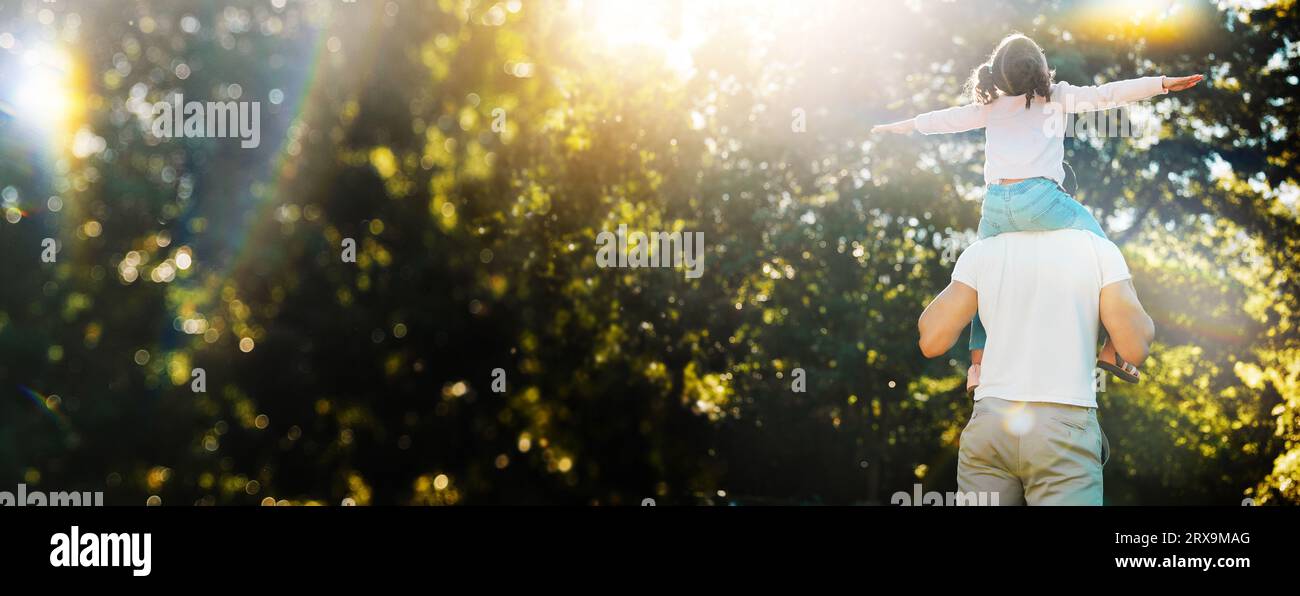 Piggyback, father and child fly outdoor on banner in nature, support ...