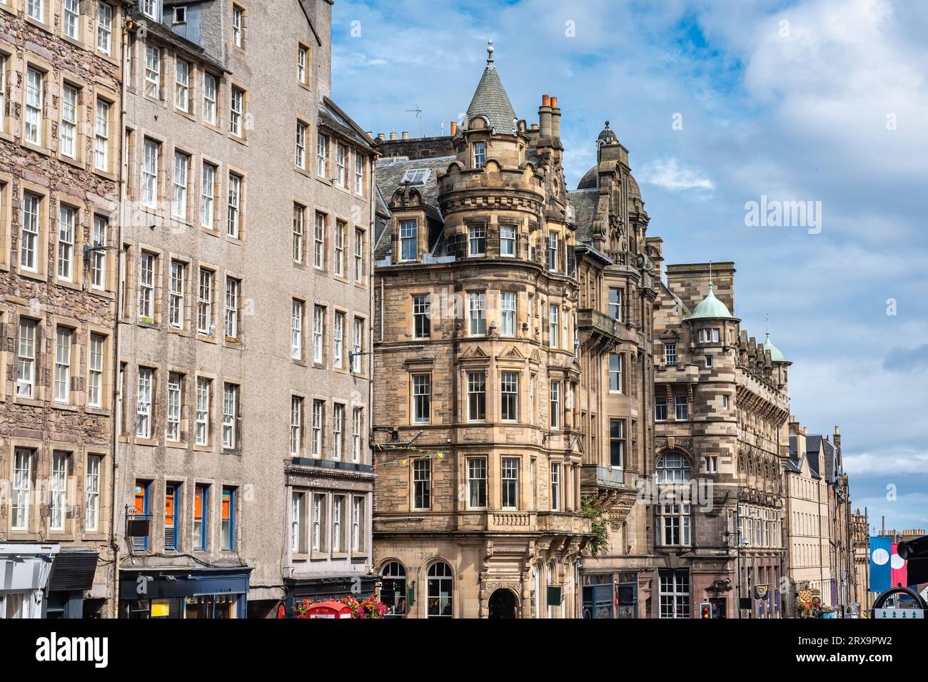Facades of historic buildings on the busy Royal Mile of the city of ...
