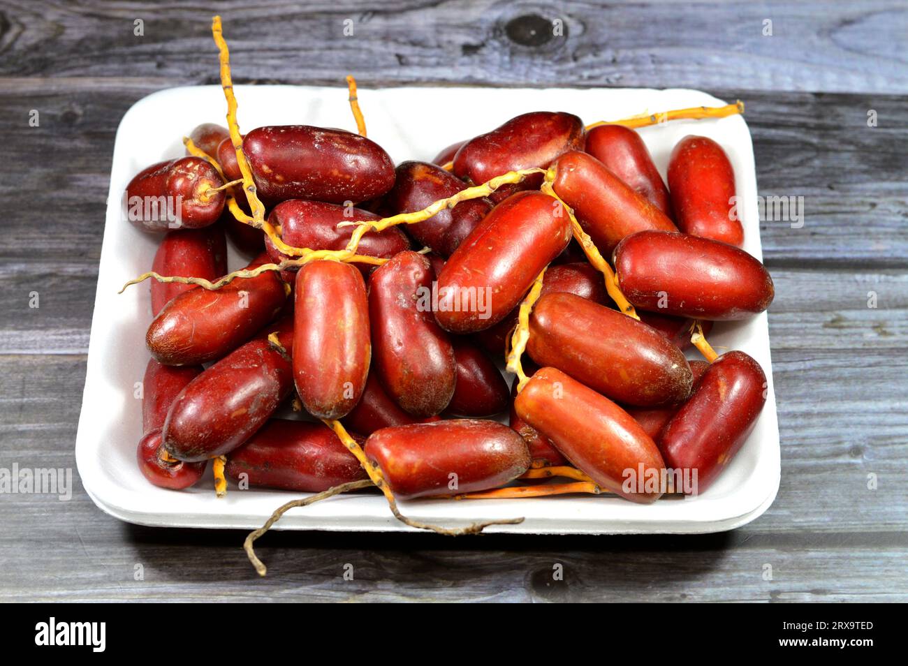 Zaghloul Egyptian red dates grow by the dozens on long yellow stems ...