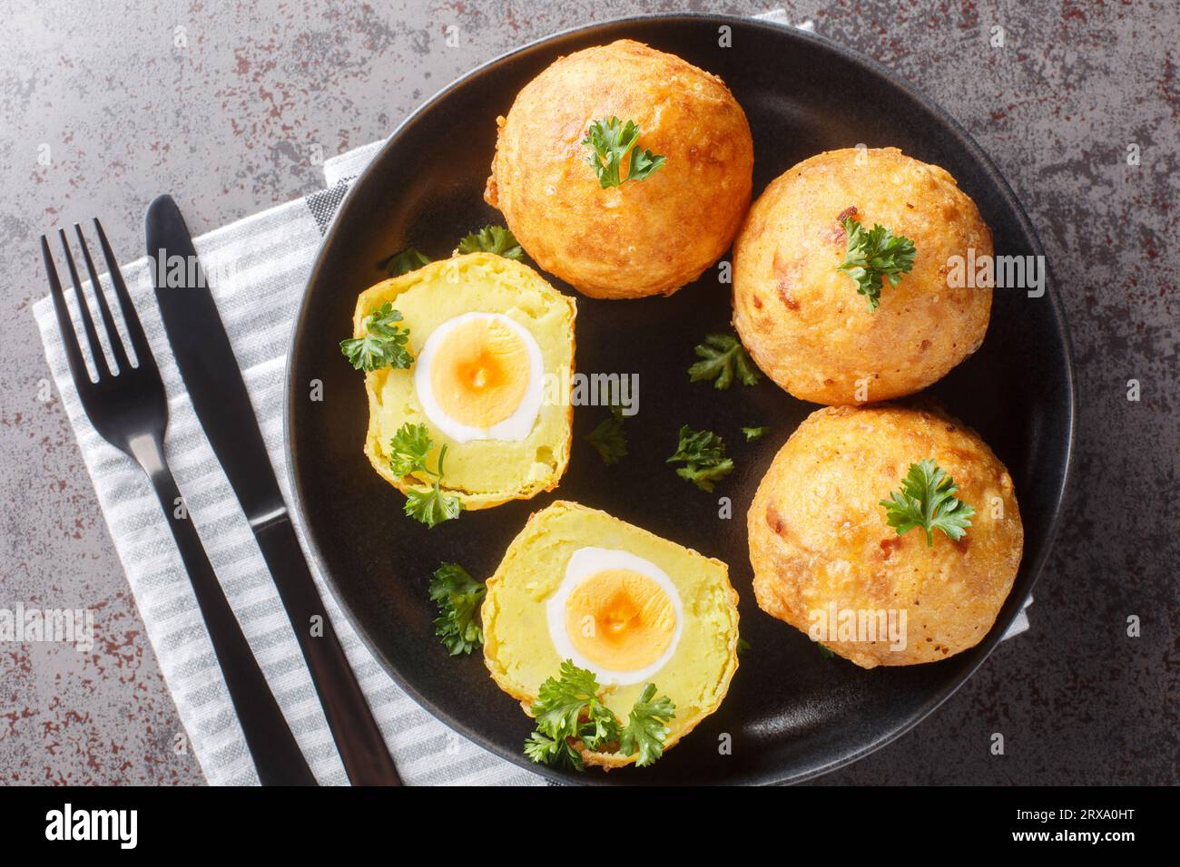 Balls of mashed potatoes stuffed with boiled egg and then fried close ...