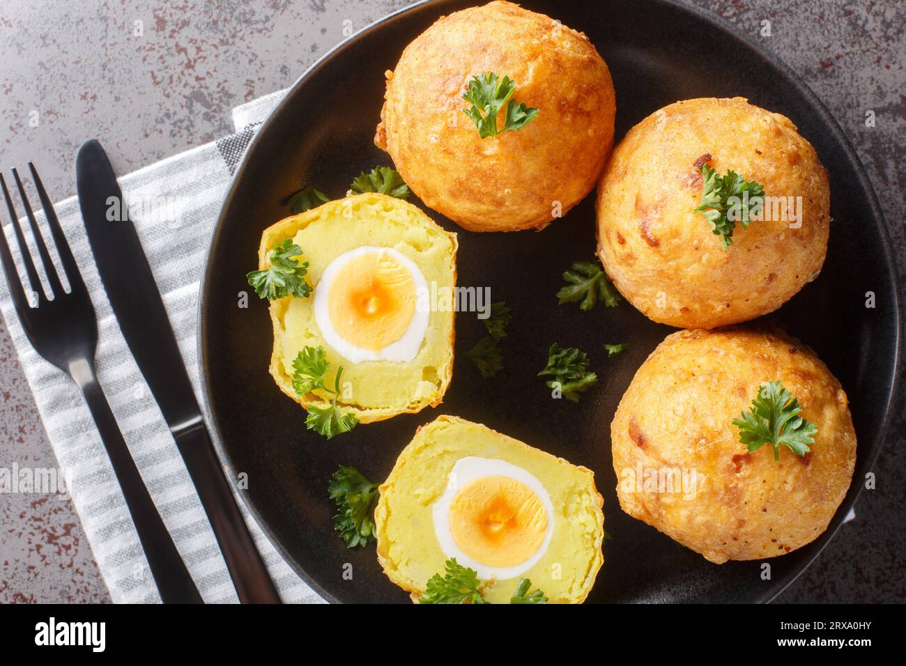 Crispy balls of cassava puree with eggs, deep fried close-up in a plate ...