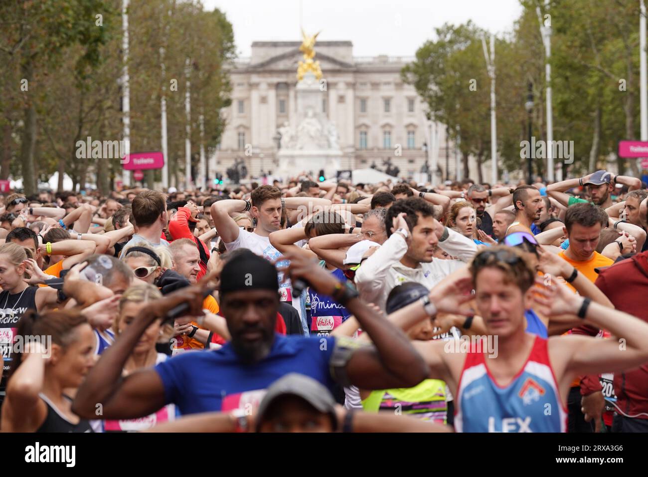 Competitors take part in warm up exercises before the start on The Mall ...