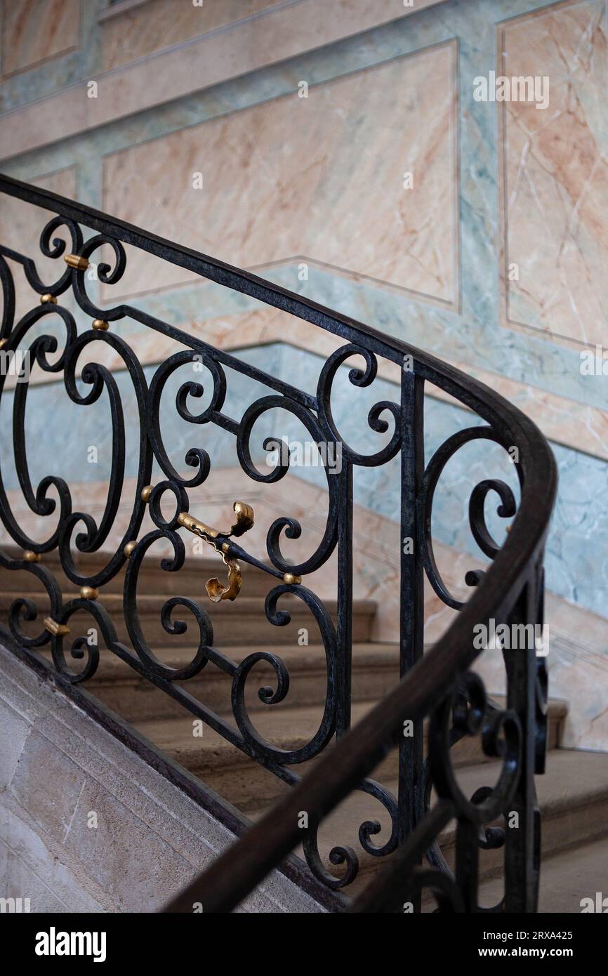 Wrought iron banister and stone staircase Stock Photo - Alamy