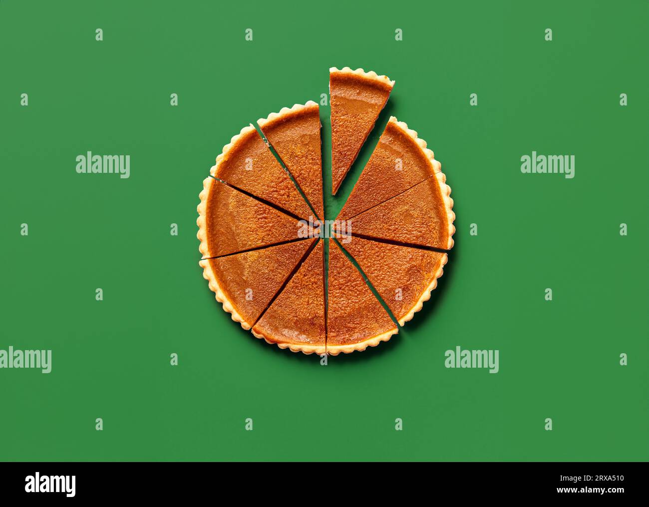Above view with a pumpkin pie sliced in equal portions, minimalist on a ...