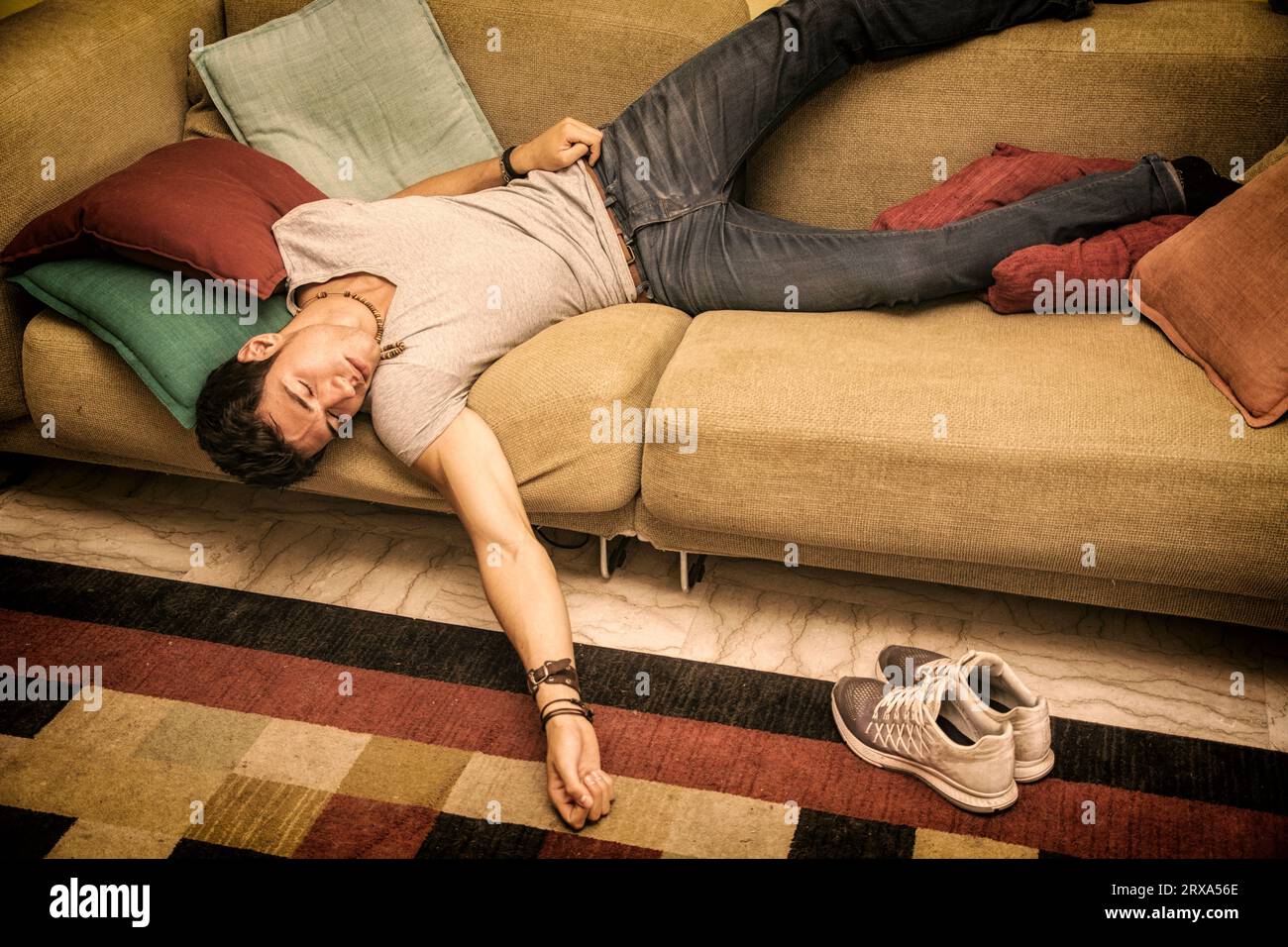 Photo of a young and handsome man resting in a strange position on the ...