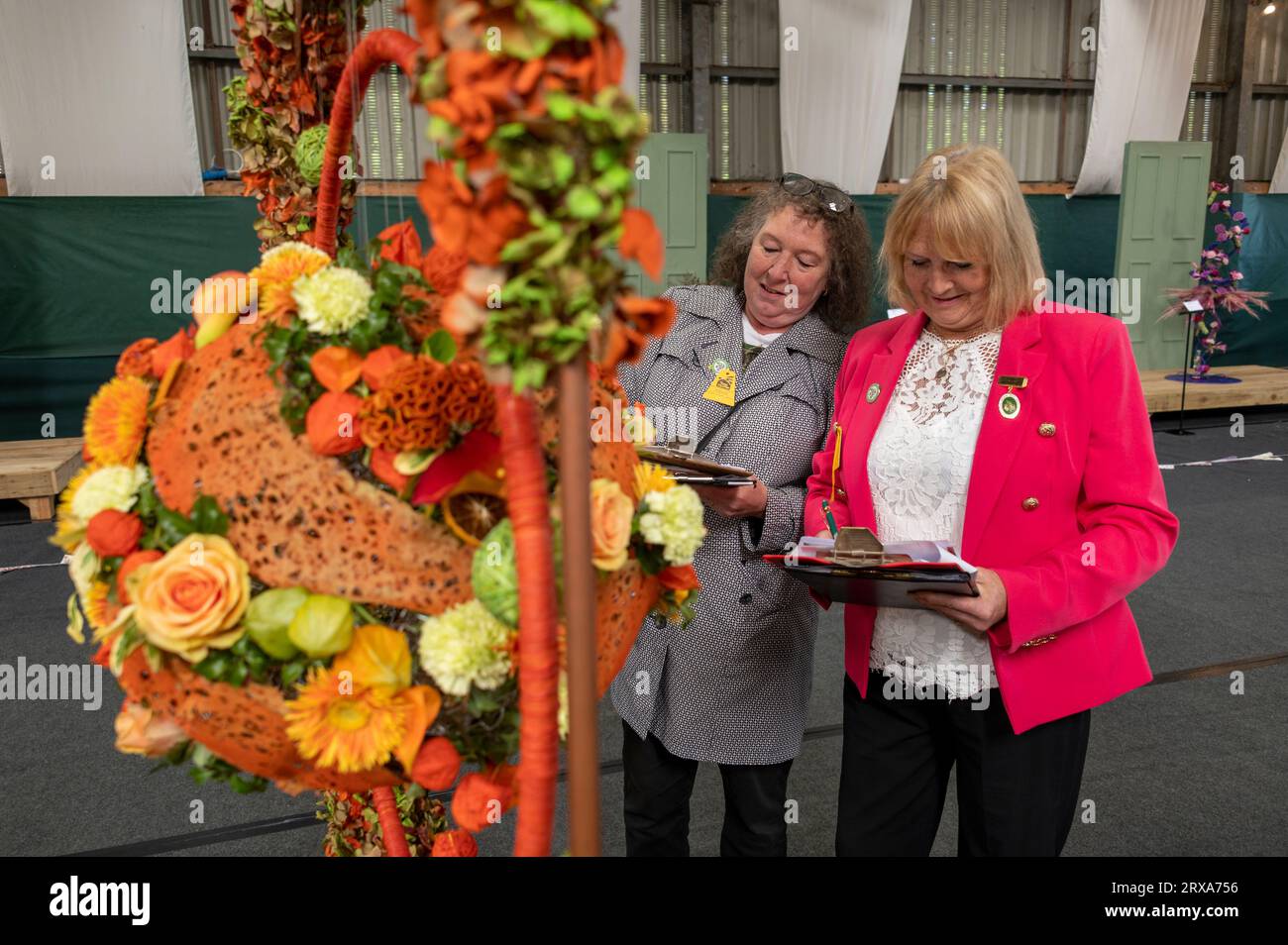 Two judges admiring one of the many arranged floral displays in the ...