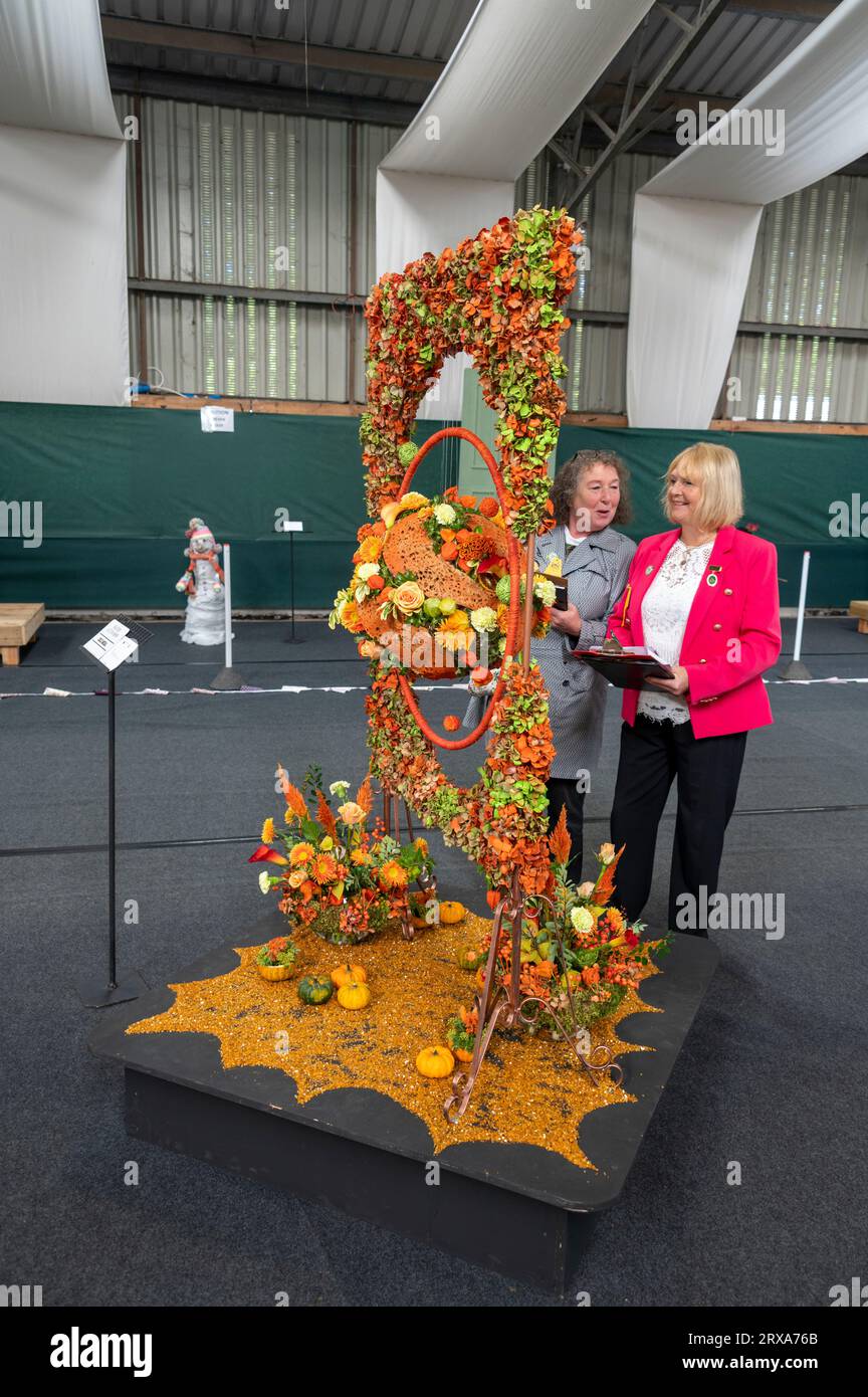 Two judges admiring one of the many arranged floral displays in the ...