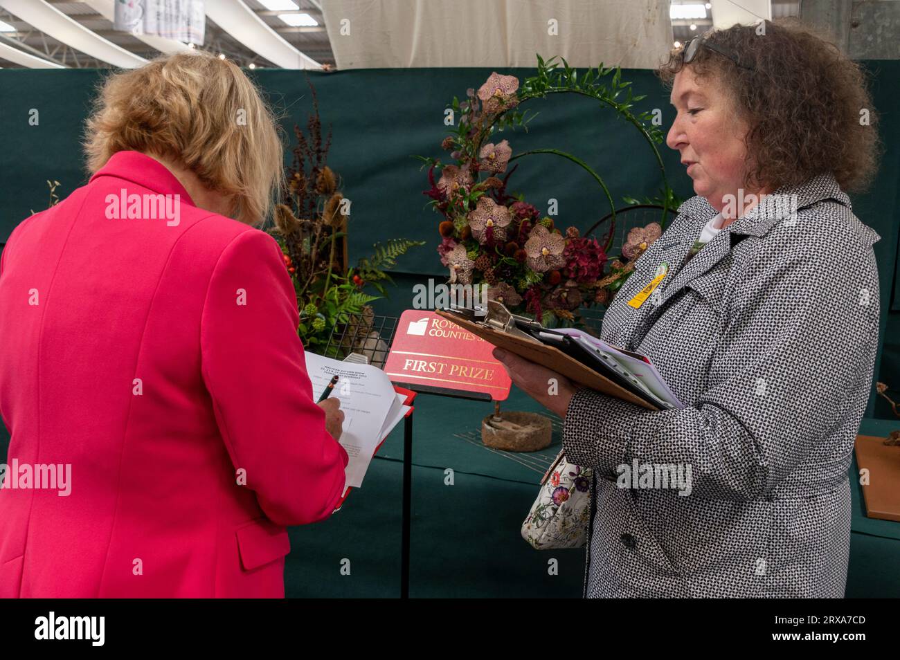Two judges making and comparing notes at some of the many exhibits in ...
