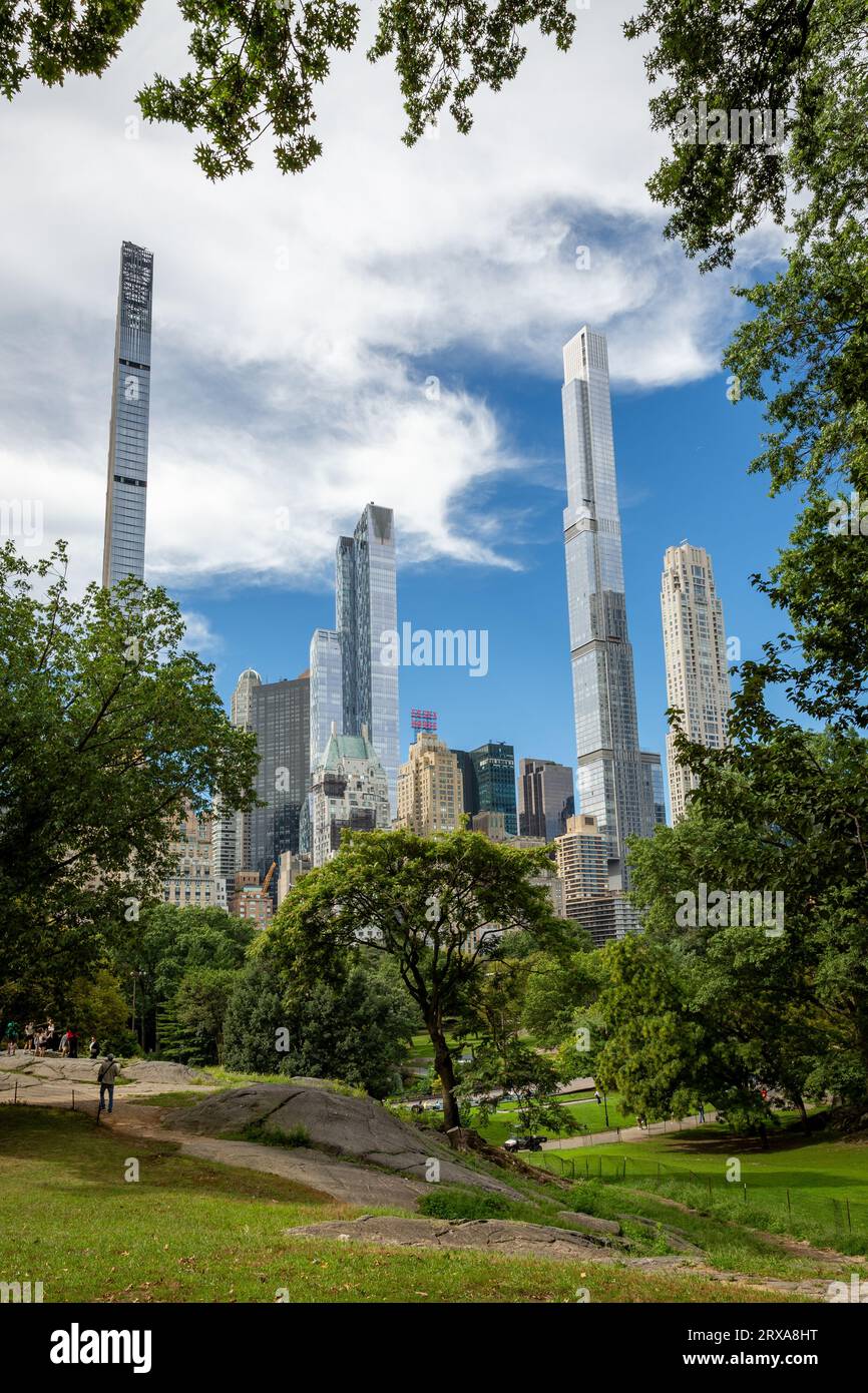 The tall skyscrapers of Midtown Manhattan framed by the green trees and ...