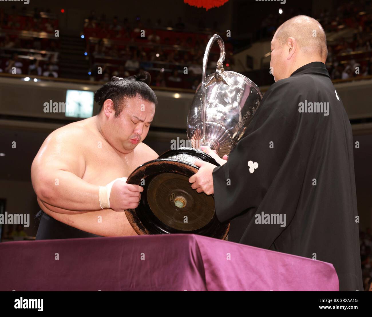 Takakeisho of Ozeki receives a victory trophy after winning play off ...