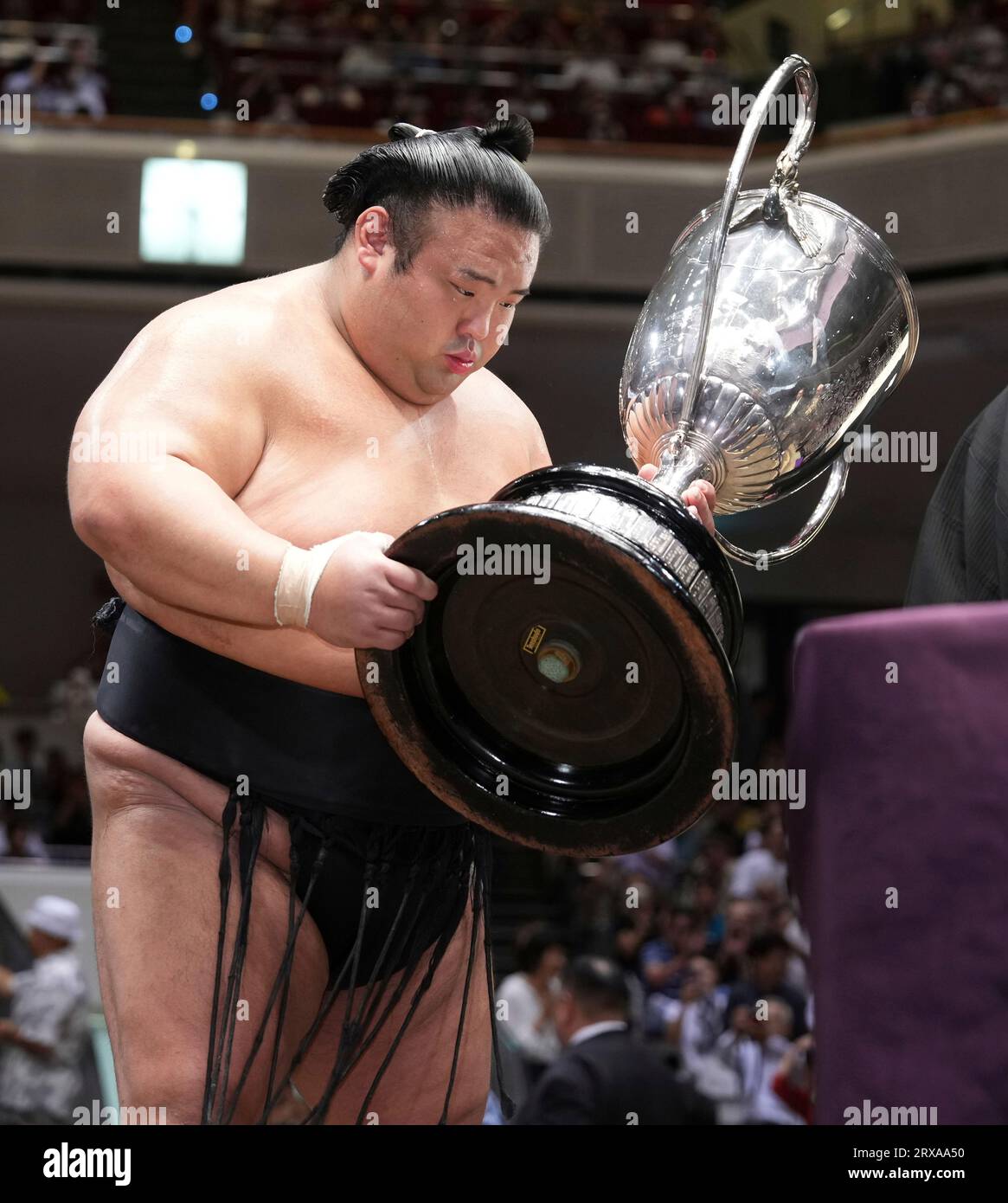 Takakeisho of Ozeki receives a victory trophy after winning play off ...
