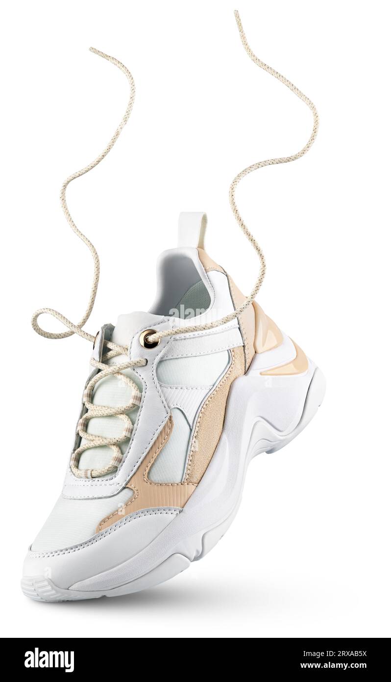 White sneaker with flying laces stands on the tip isolated on white ...