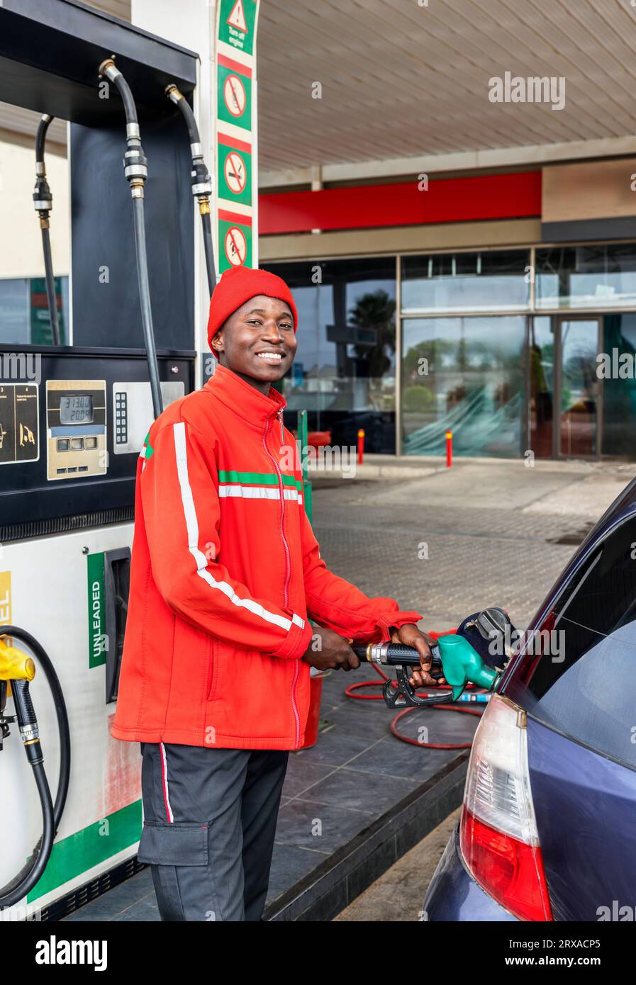 african american man attendant in red uniform and a smiley face at the ...