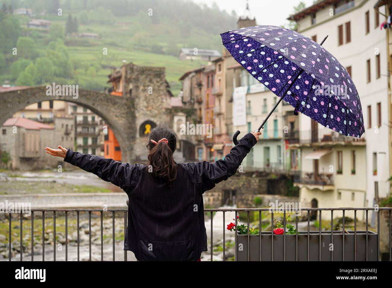celebrating the rain against the drought. Woman with an umbrella in ...
