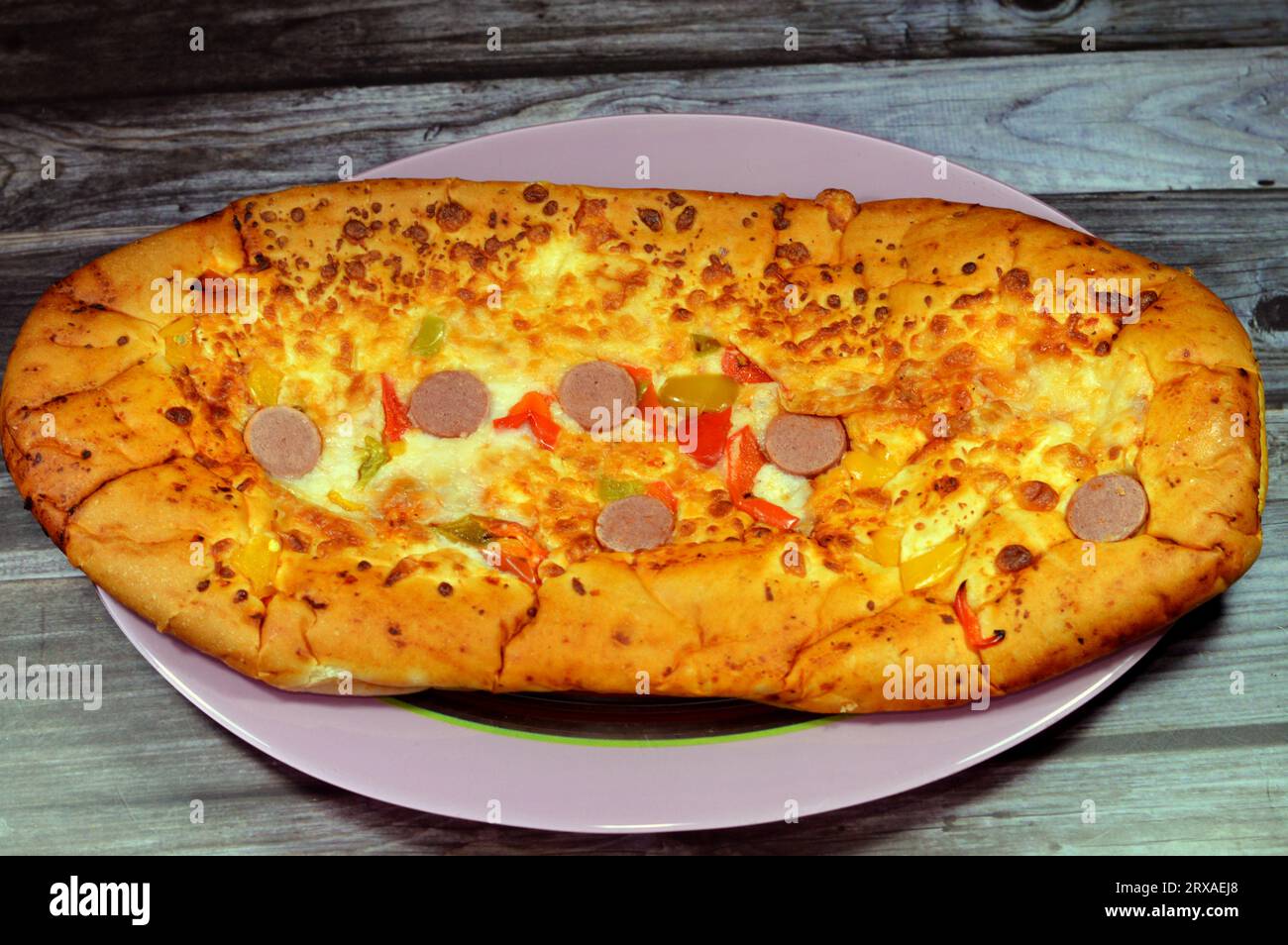 Cheese Fougasse topped with slices of green peppers, cheese, and cut ...