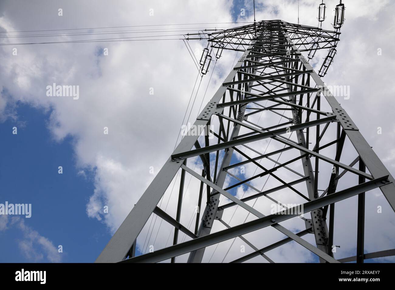 View from below of the tall poles of the high-voltage overhead line ...
