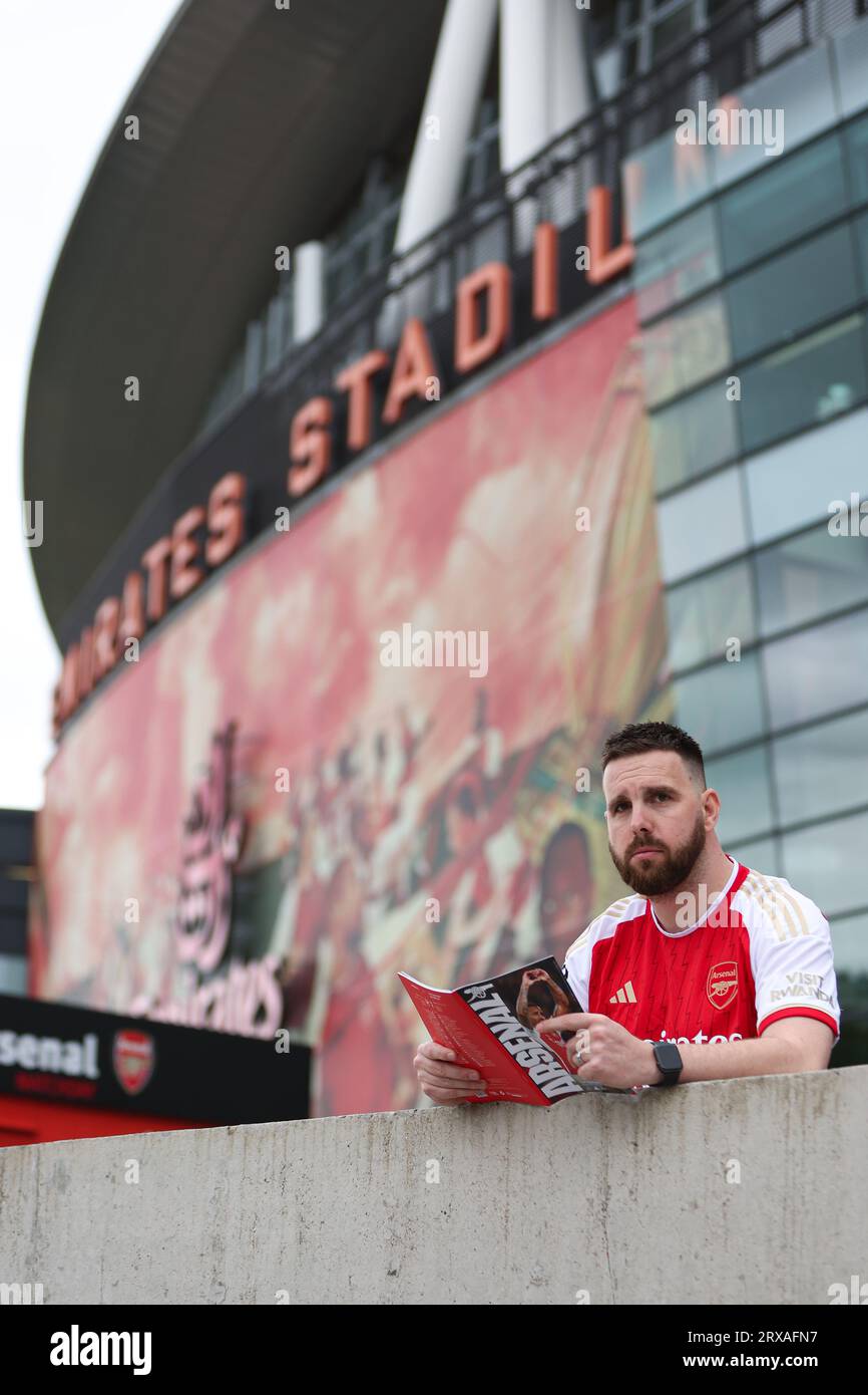 London, UK. 24th Sep, 2023. An Arsenal supporter reads the programme ...