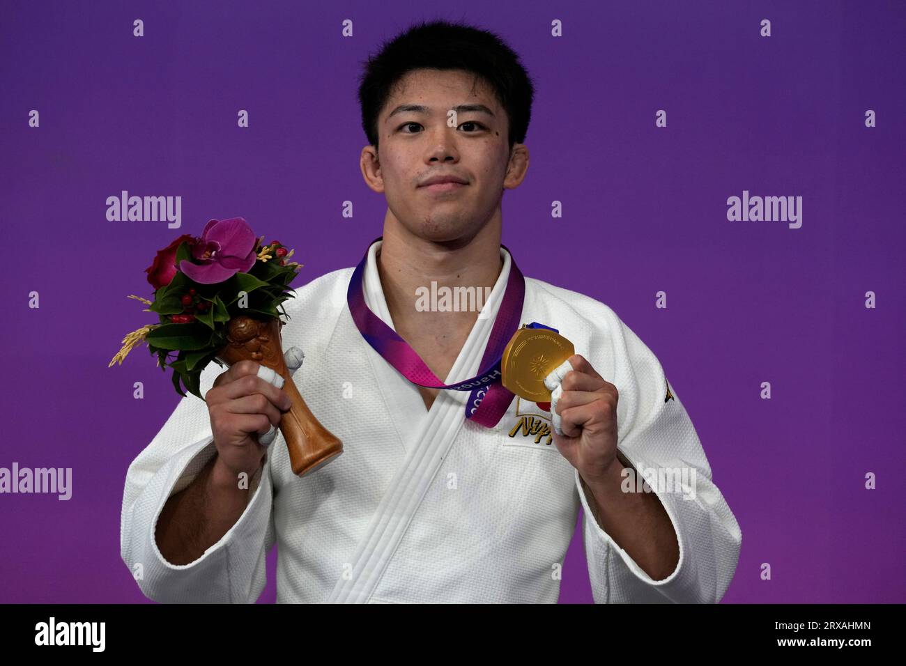 Japan's Ryoma Tanaka celebrates with his gold medal in the Men's -66Kg ...