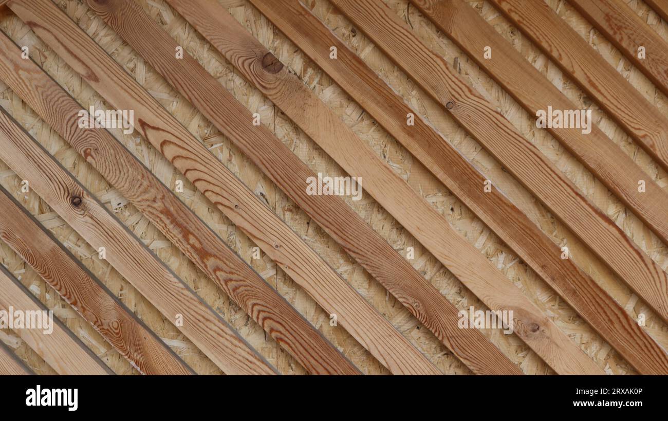wooden planks packed diagonally onto a textured surface, different wood ...