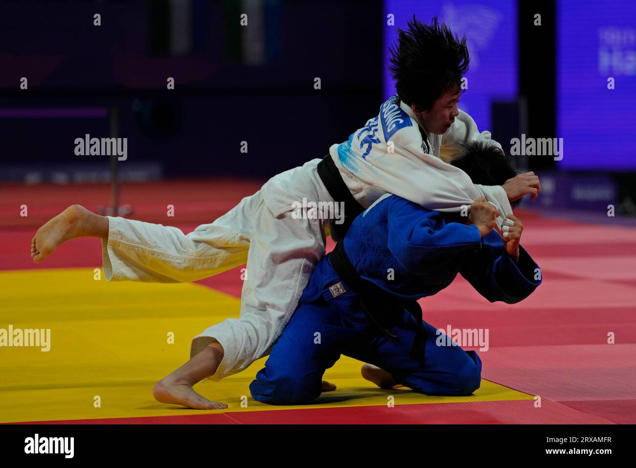 China's Guo Zongying in blue fights North Korea's Jon Susong in the ...