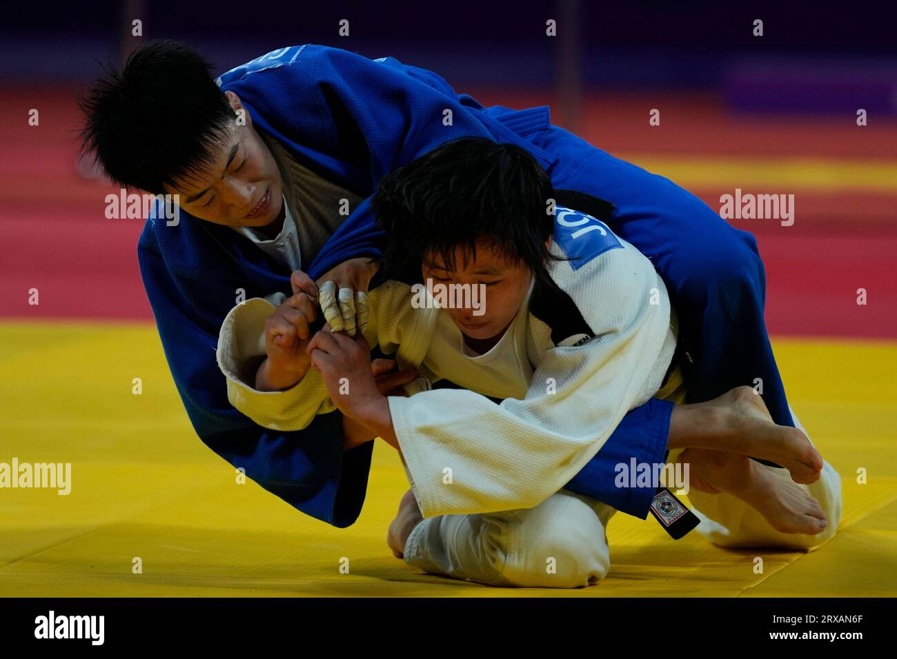 China's Guo Zongying in blue fights North Korea's Jon Susong in the ...