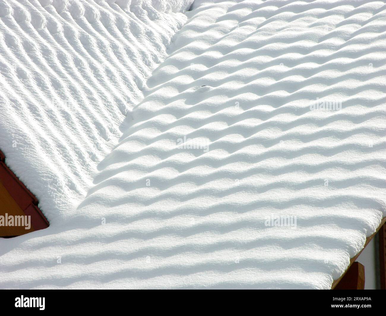 Snow-covered tiled roof Stock Photo - Alamy
