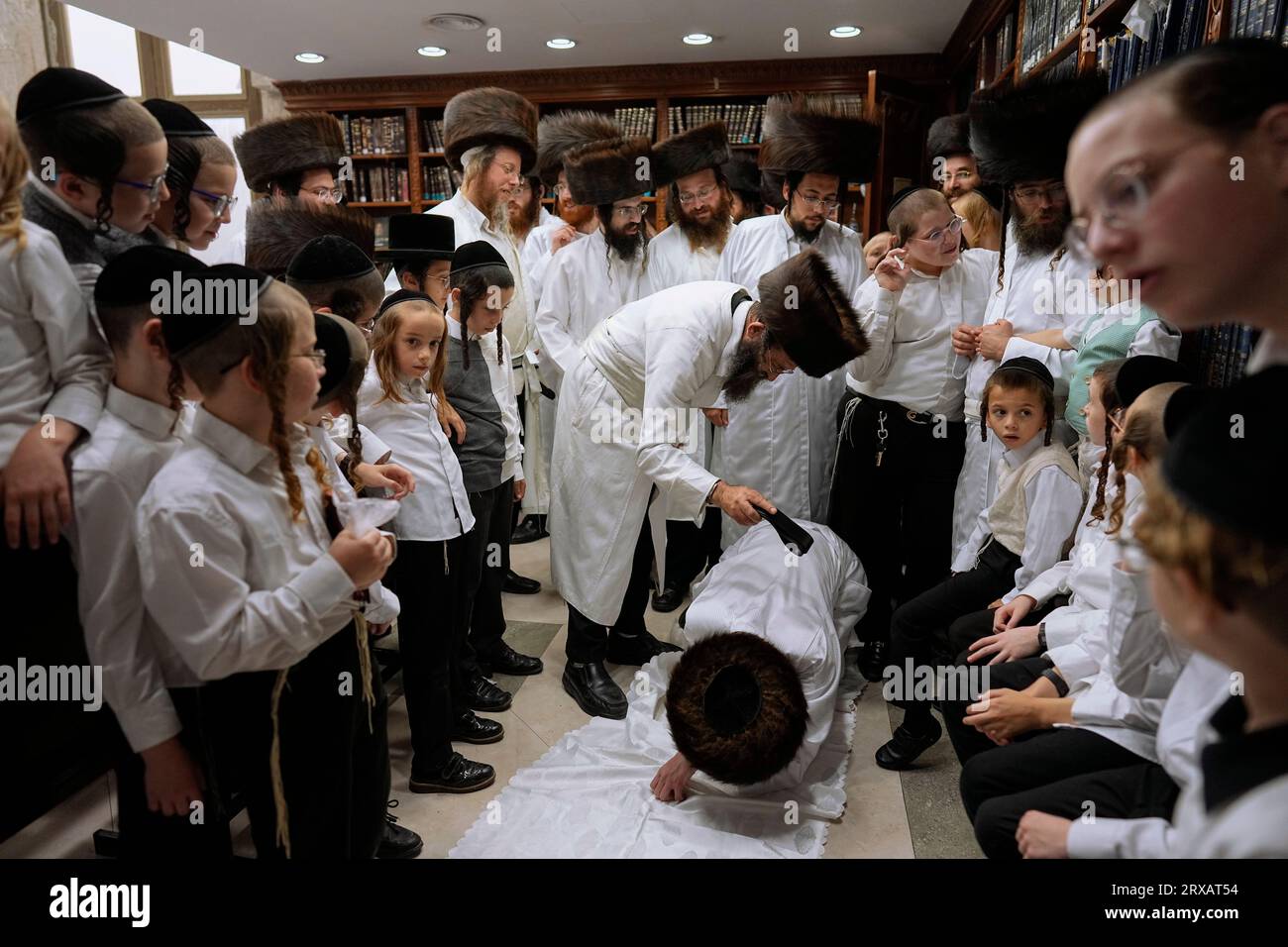 An ultra-Orthodox Jewish man whips a member of his Hasidic dynasty with ...