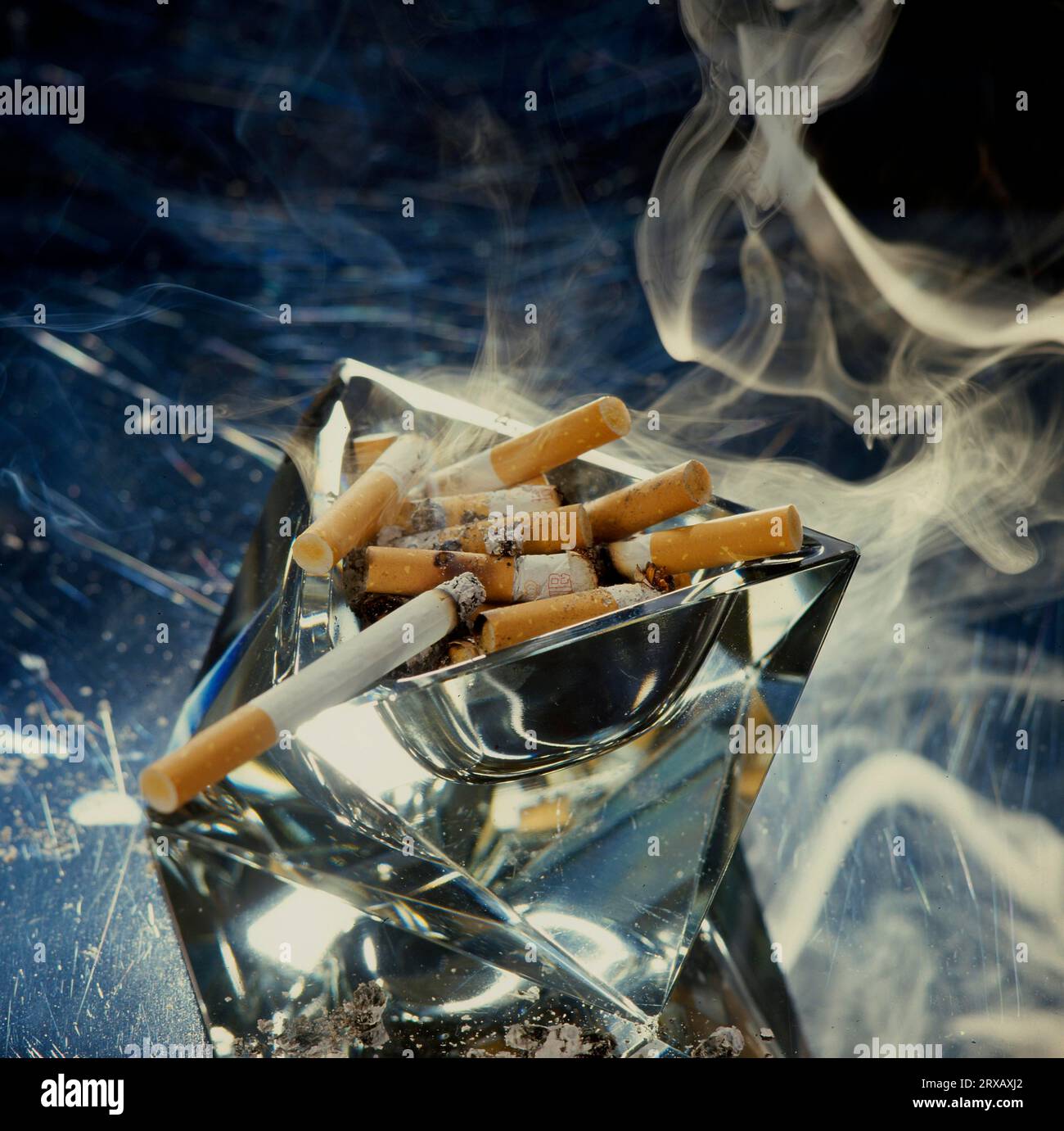 Ashtray with smoking cigarette butts Stock Photo - Alamy