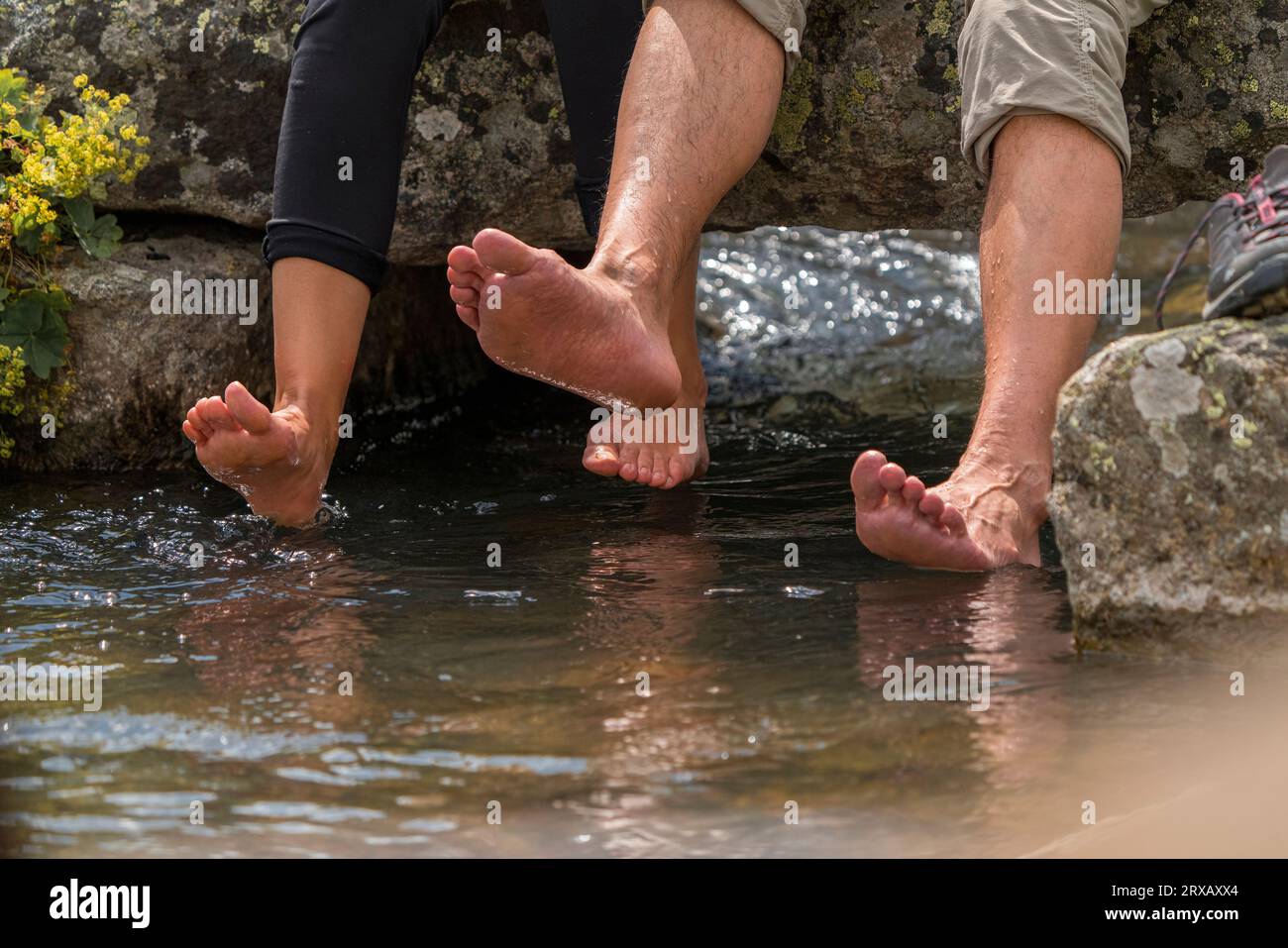 Putting your feet in the water from the mountain Stock Photo - Alamy