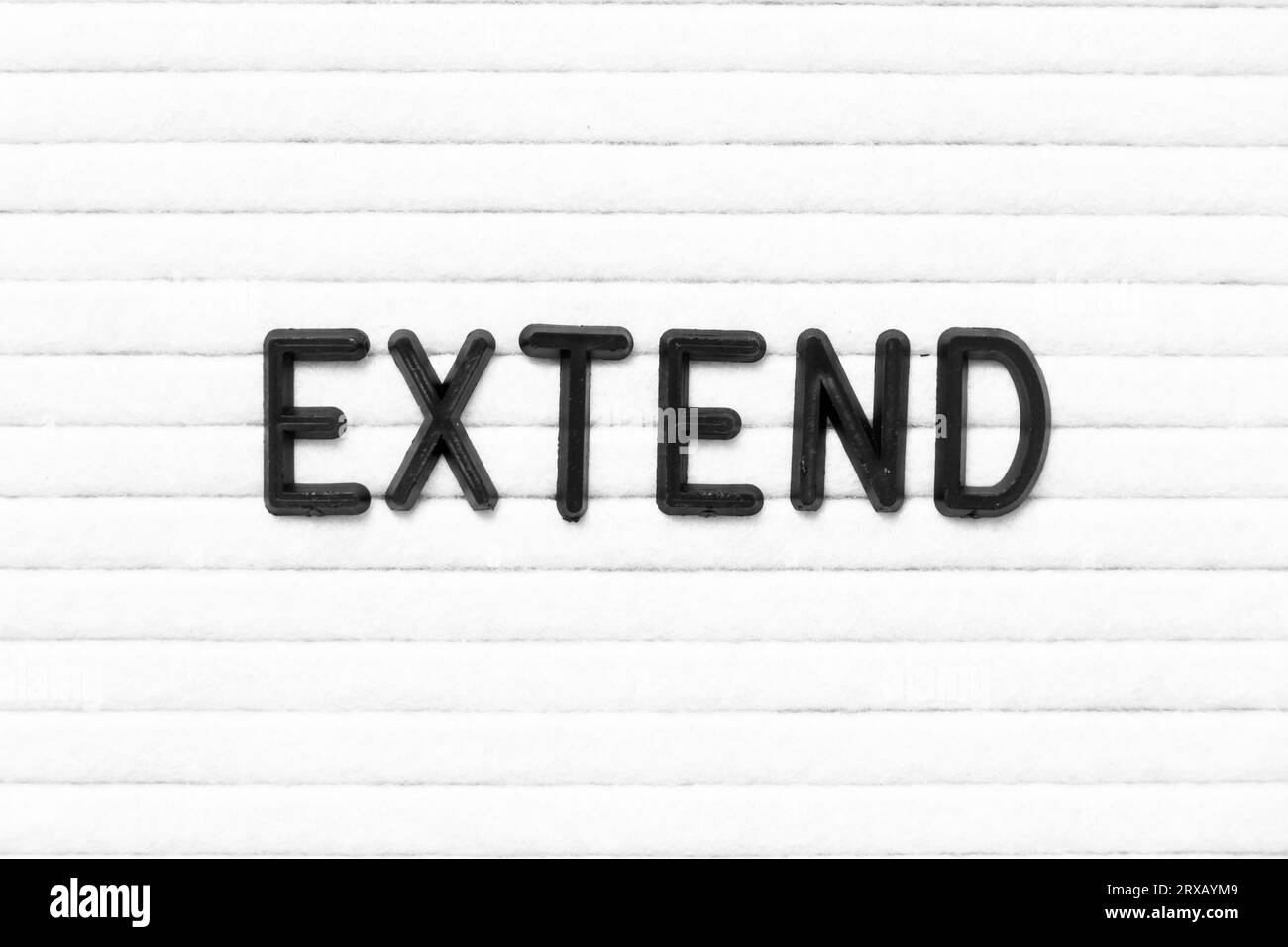 Black color letter in word extend on white felt board background Stock ...