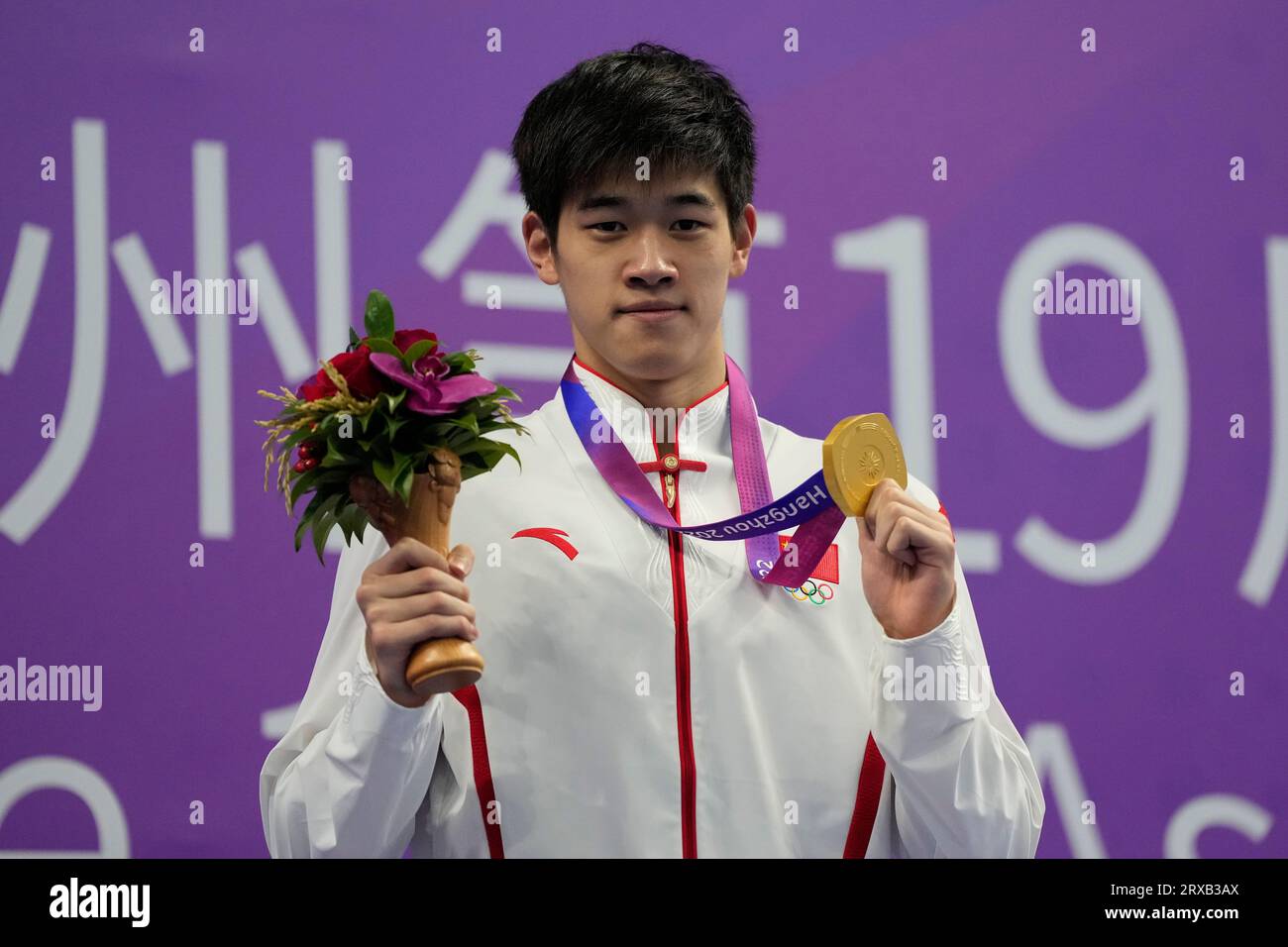 Gold medalist China's Pan Zhanle celebrates during the victory ceremony ...