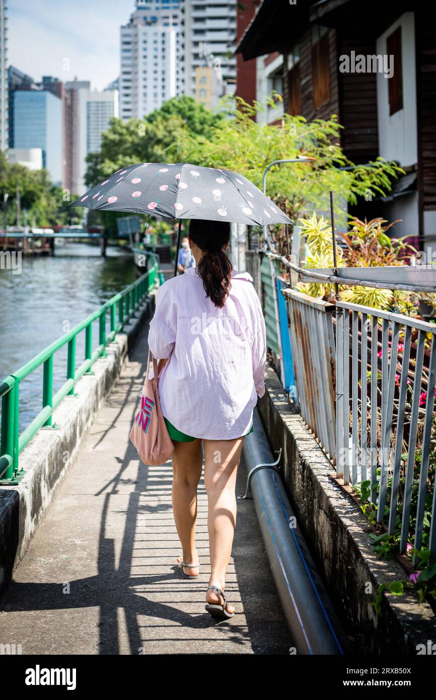 A beautiful young Thai girl makes her way along the Saen Saep Canal ...