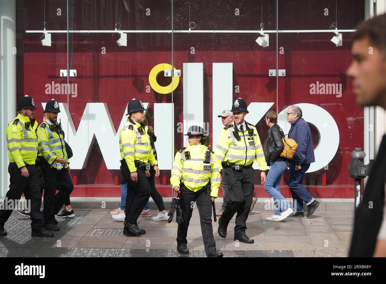 London UK. 24 September 2023 . Police officers walk past a a Wilko sign ...