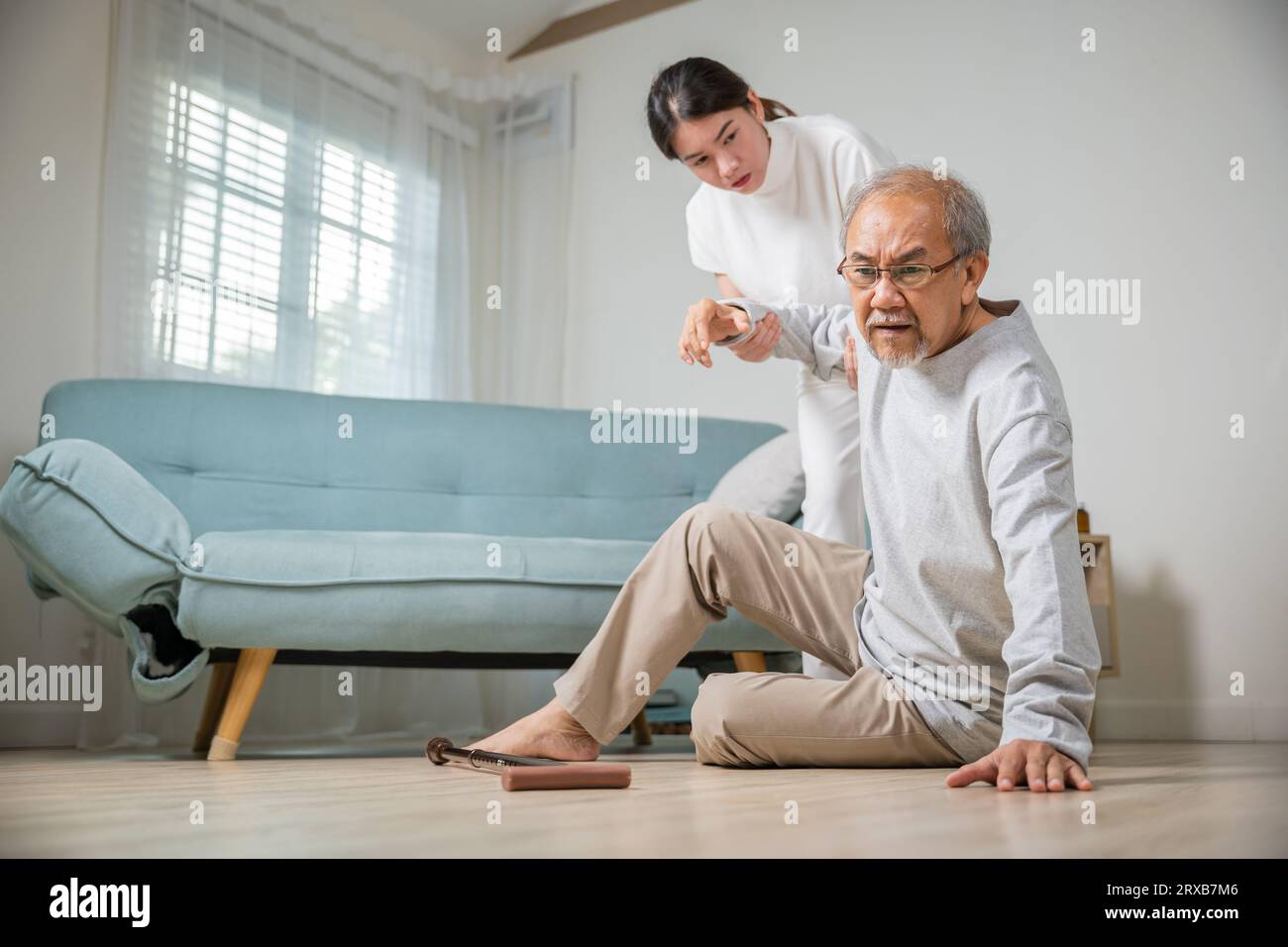 old man falling down lying on floor with walking stick and assistant ...