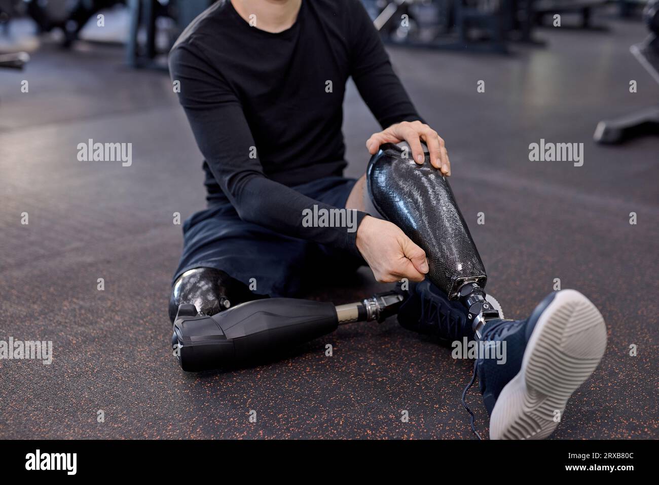 guy in stylish sportswear taking off his prosthetic leg after workout ...