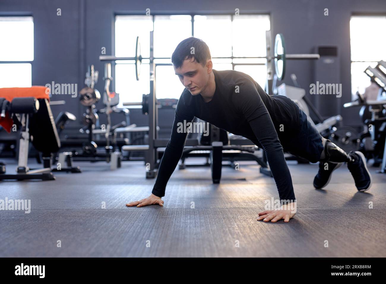 never give up, motivated gorgeous man doing press-up exercises at gym ...