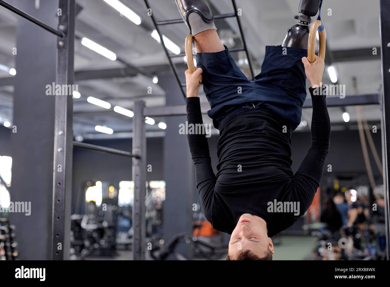 young man without legs hanging with the help of his strong muscular ...