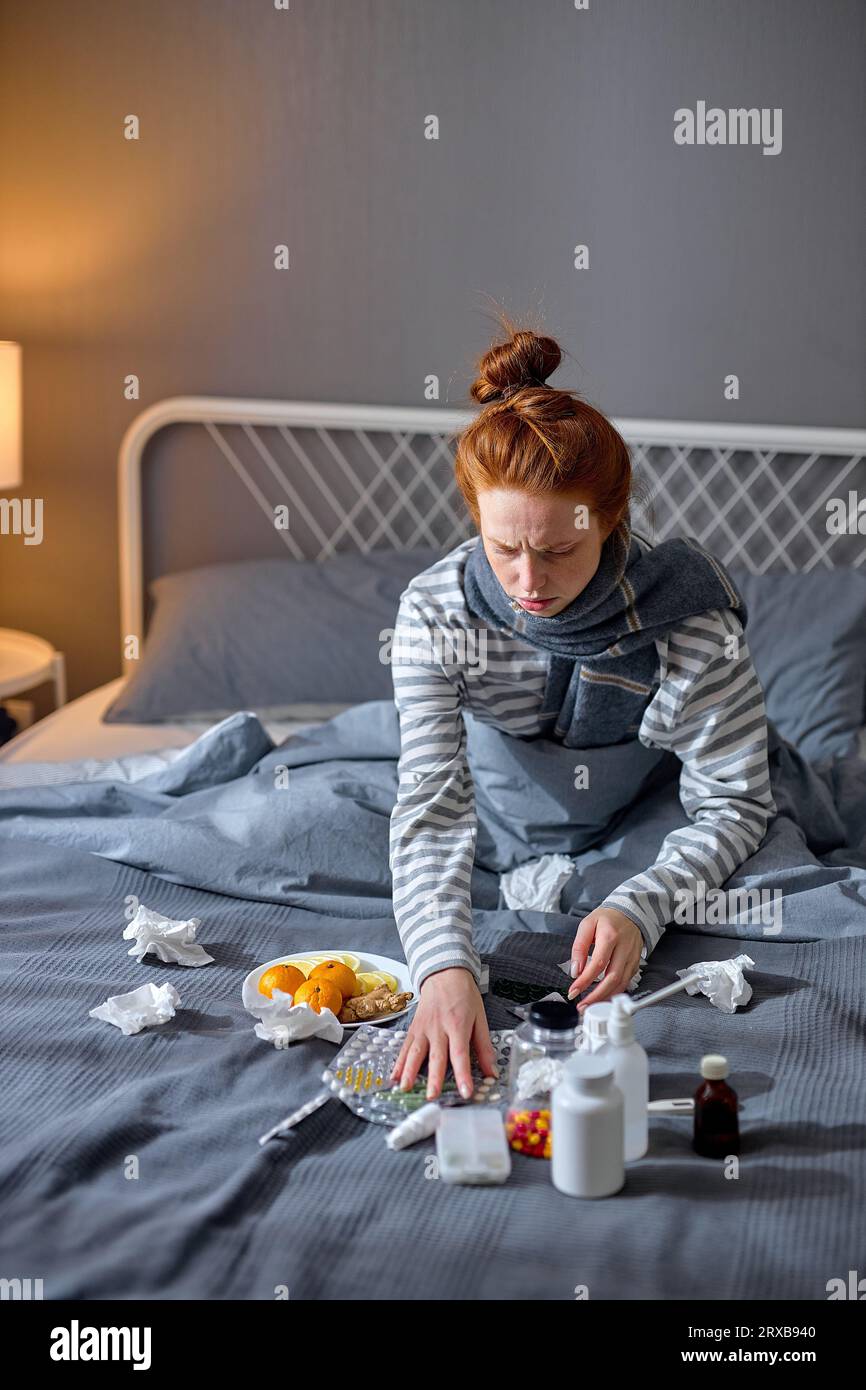 sad woman is fed up ill, she choosing pills to relief her pain in ...