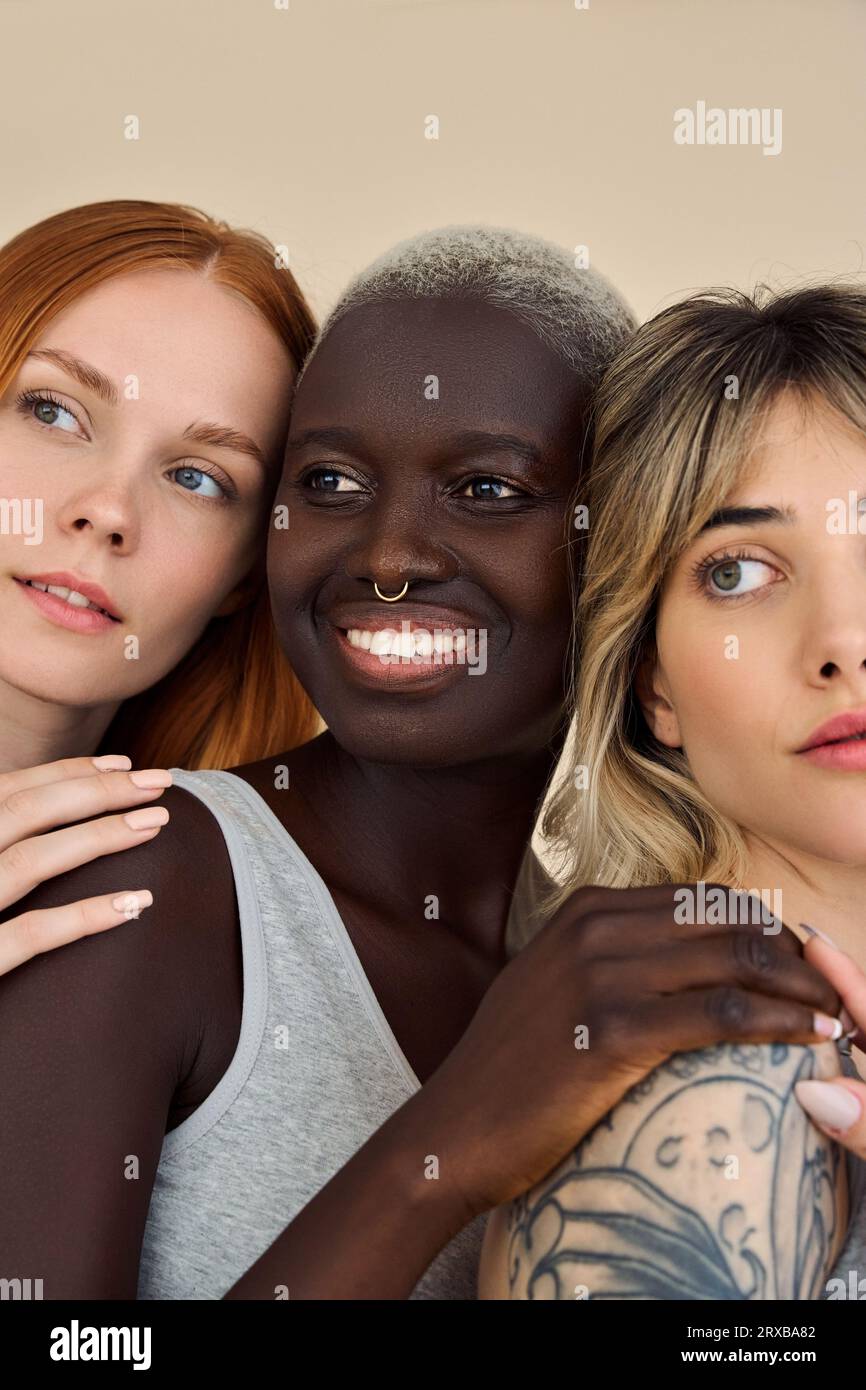 Three happy cool pretty gen z girls looking away, vertical beauty ...