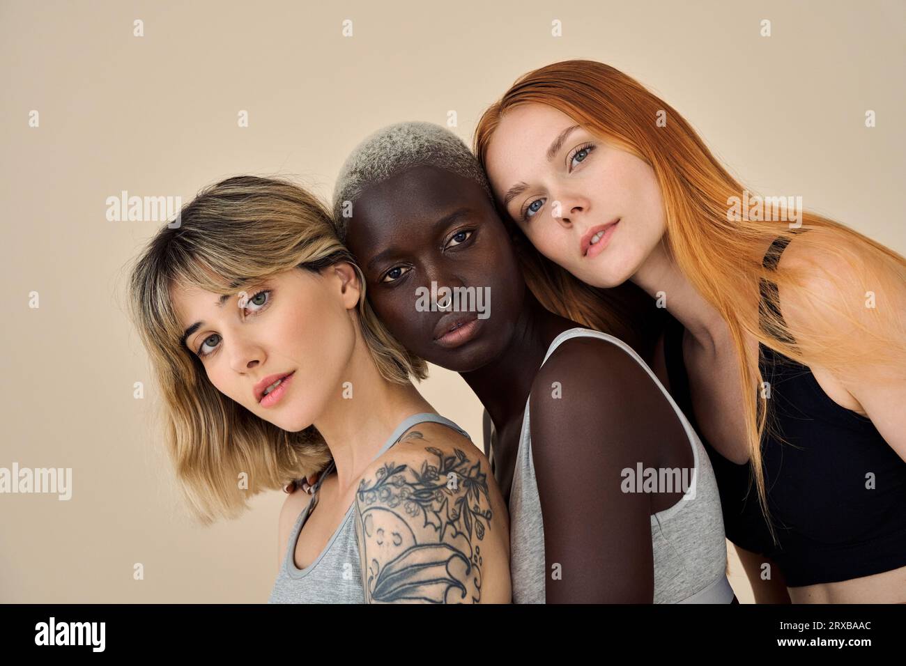Three cool confident pretty gen z girls looking at camera, beauty ...