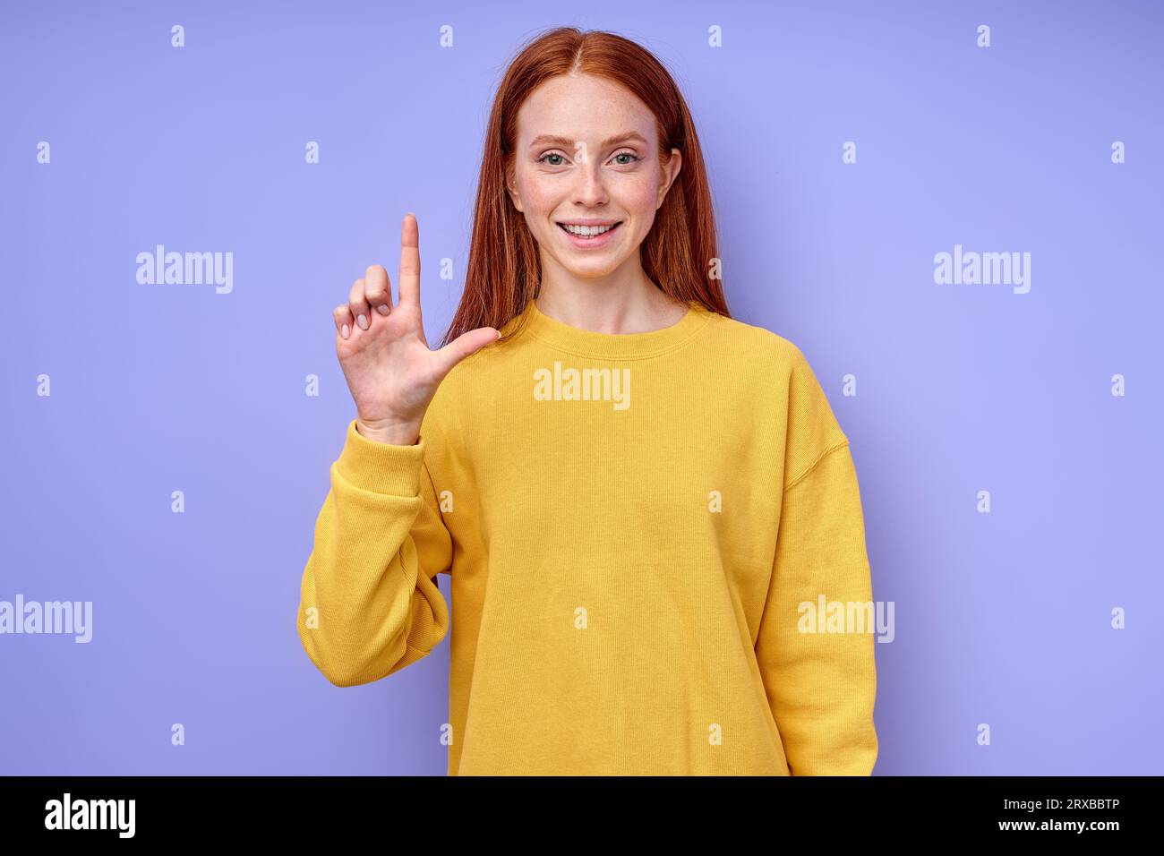 beautiful happy cheerful redhead woman in yellow stylish sweater ...