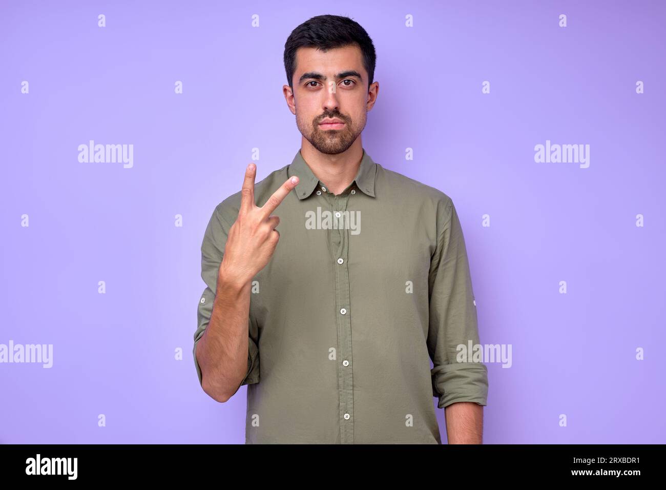 serious handsome man showing letter V v with fingers .the Alphabet in ...