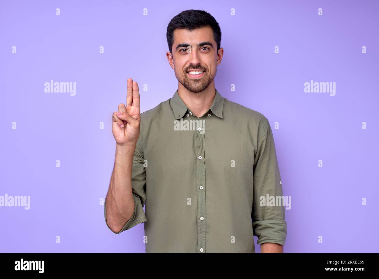 cheerful brunette bearded man demonstrating the letter U u. sign ...