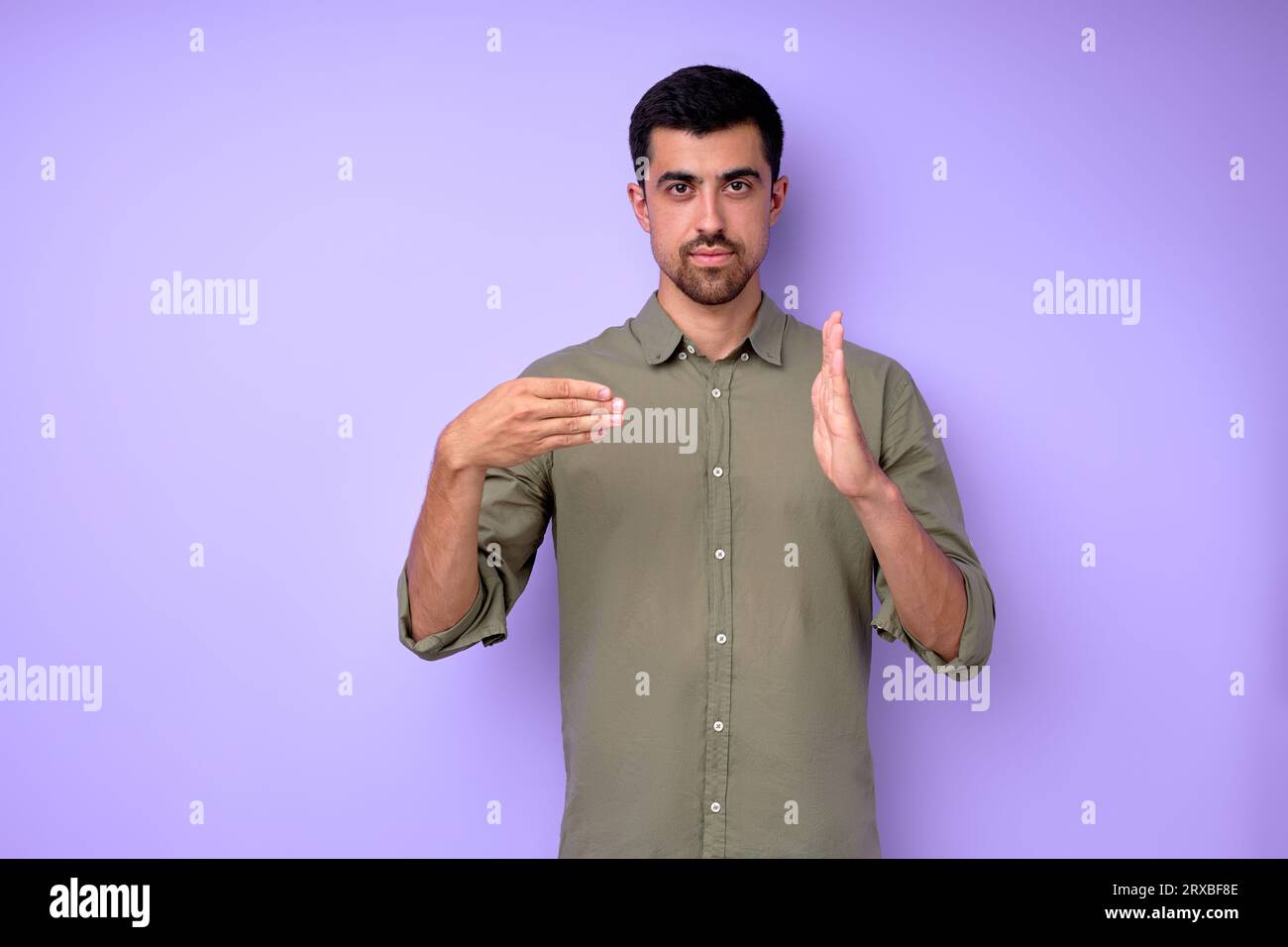 Young serious bearded deaf mute man showing number 400 using sign ...