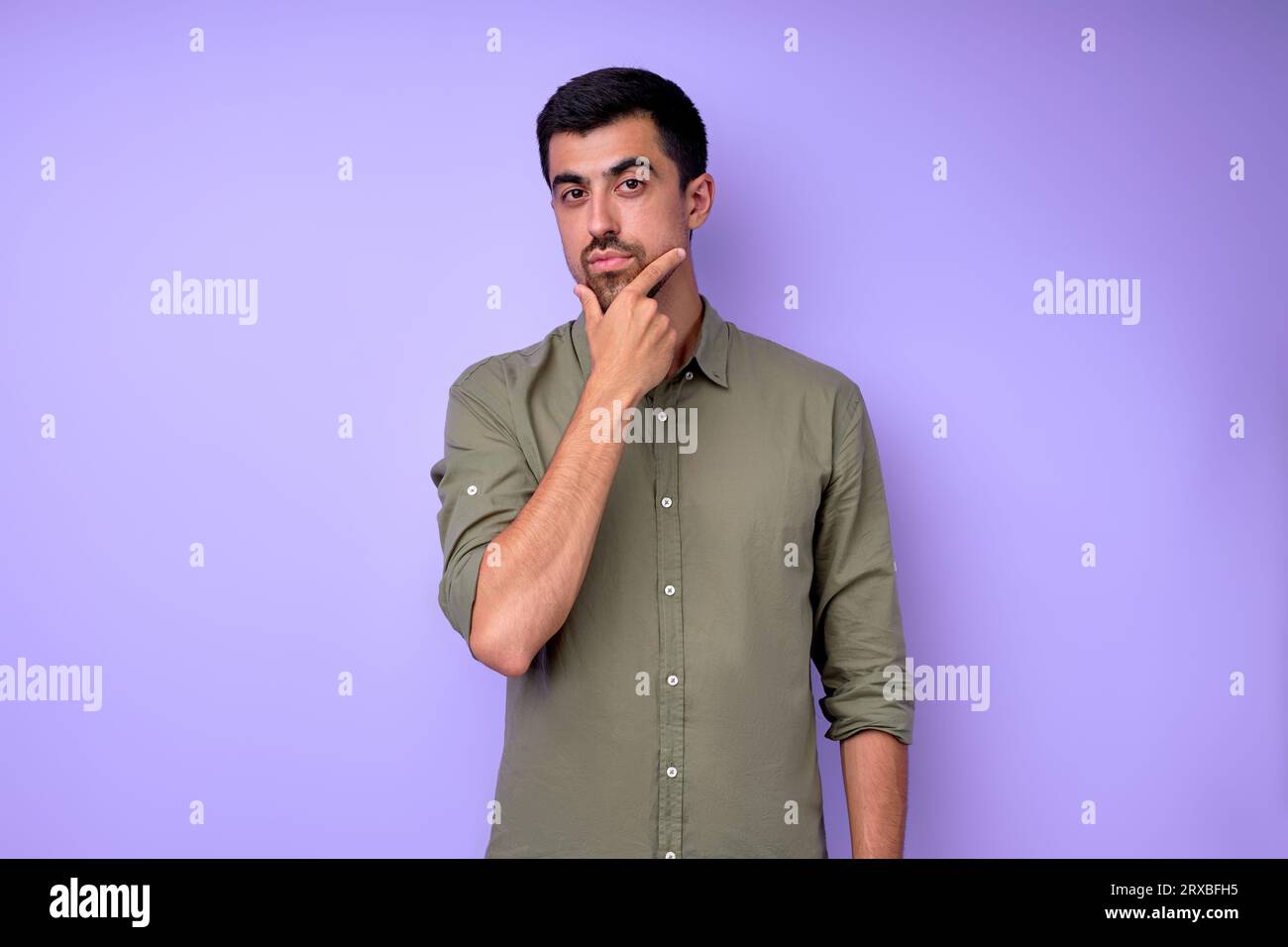 Young serious bearded deaf mute man with hand on his forehead showing ...